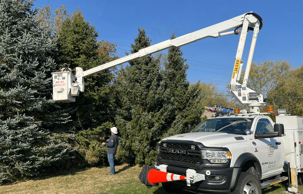 Bucket trucks help trim trees at Santa's House